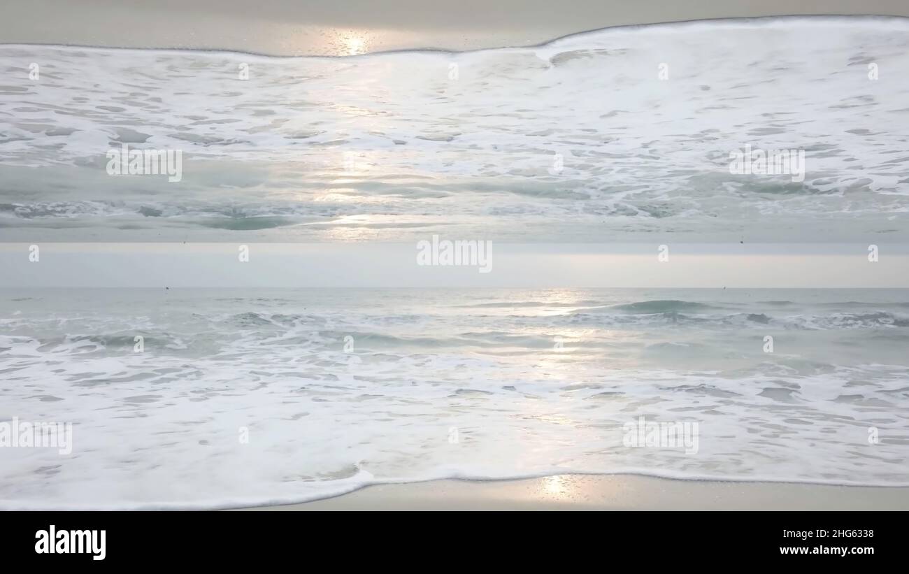 Beautiful seascape with horizon mirror effect with waves crashing on ...