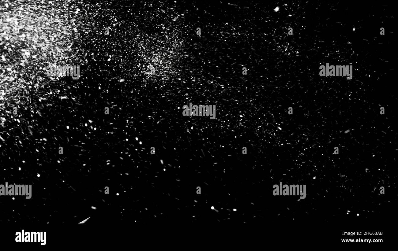 Abstract white dust particles floating on black background, monochrome ...