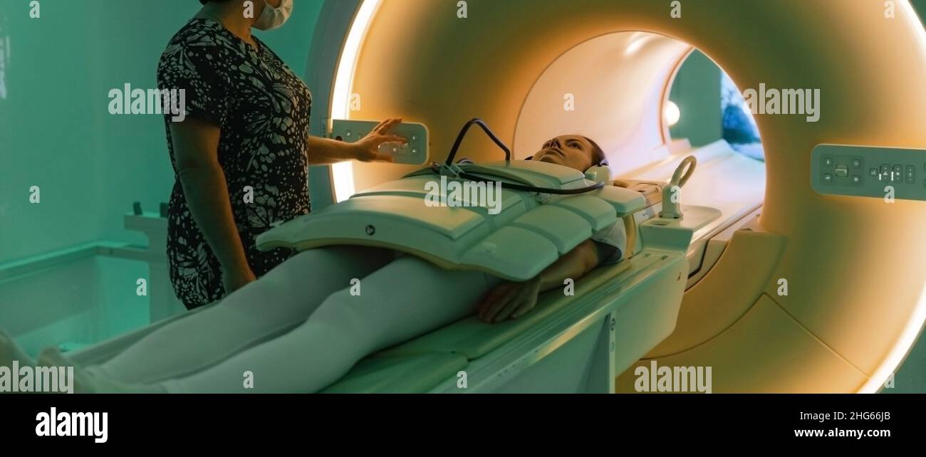 Doctor or nurse and patient with tomography CT or MRI Scan in hospital ...