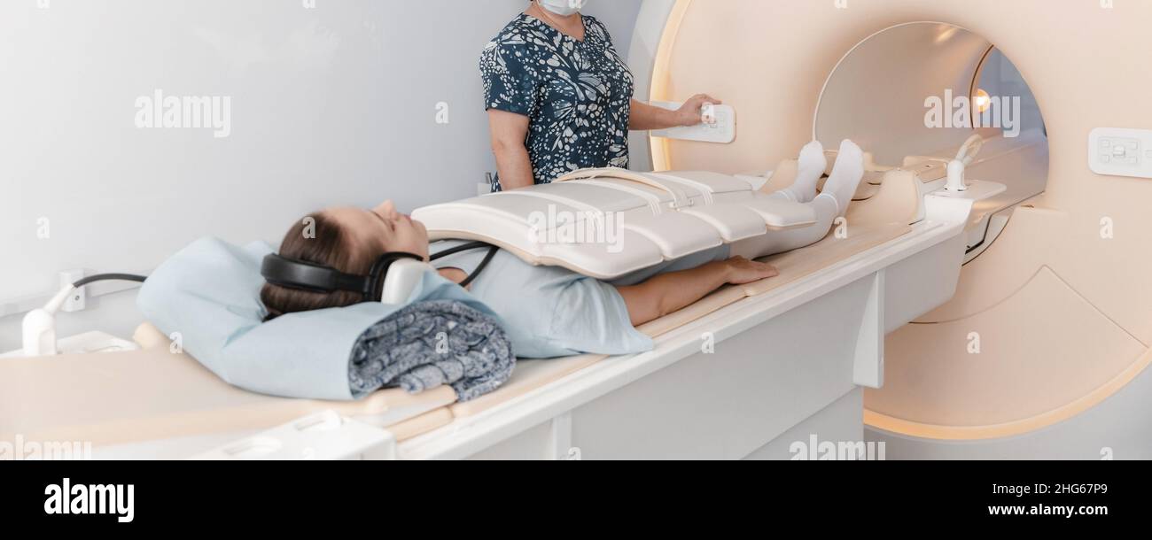 Doctor or nurse and patient with tomography CT or MRI Scan in hospital ...