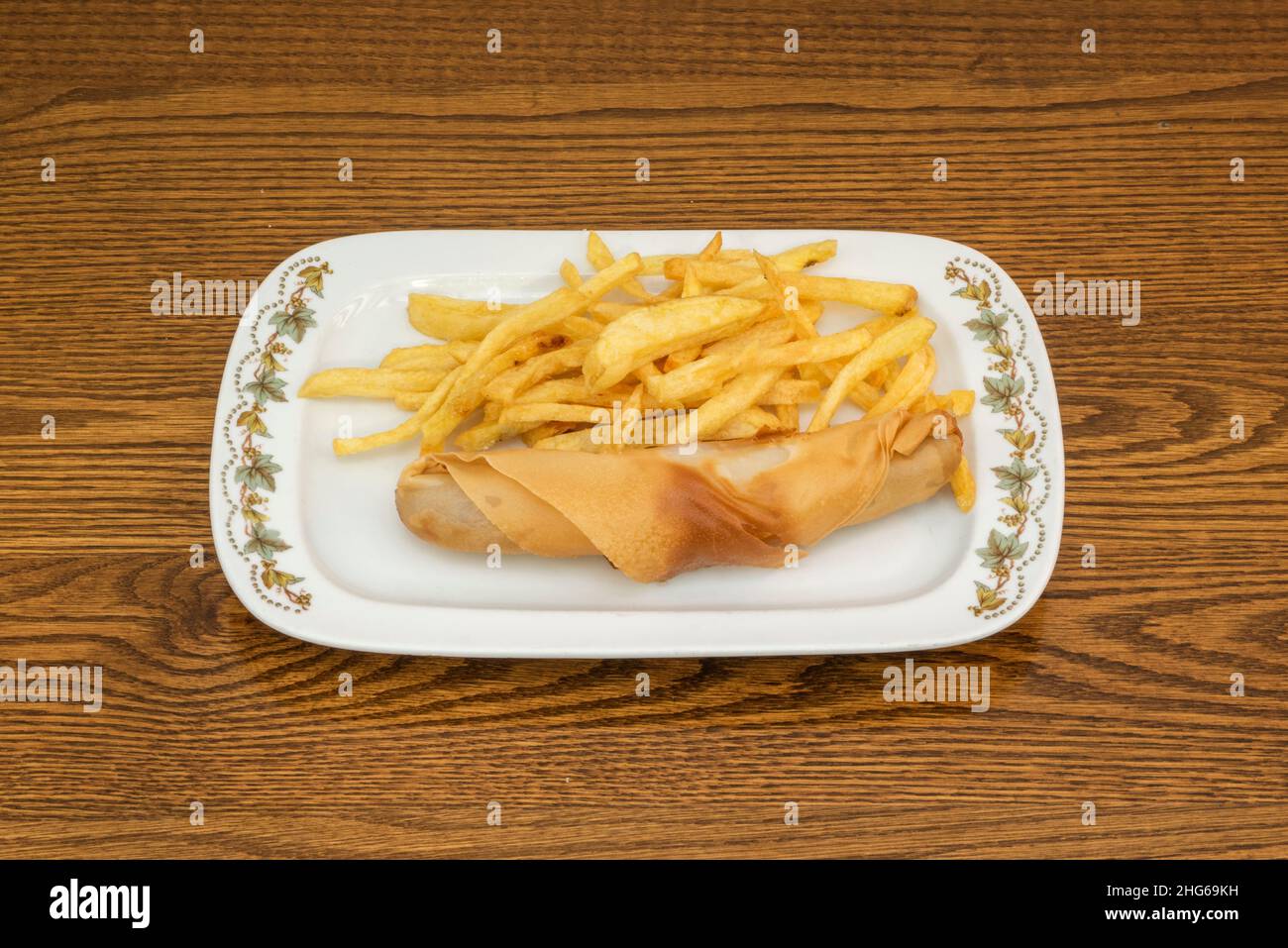 German sausage menu wrapped in crispy biscuit with fries garnish Stock ...