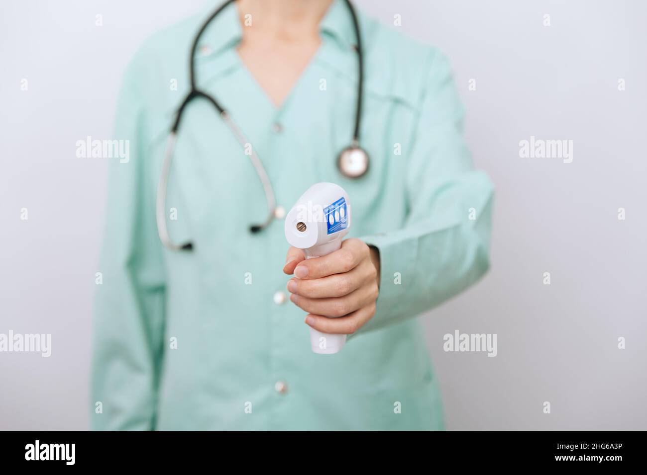 Temperature measurement gun in doctor hands. Close-up shot of doctor ...
