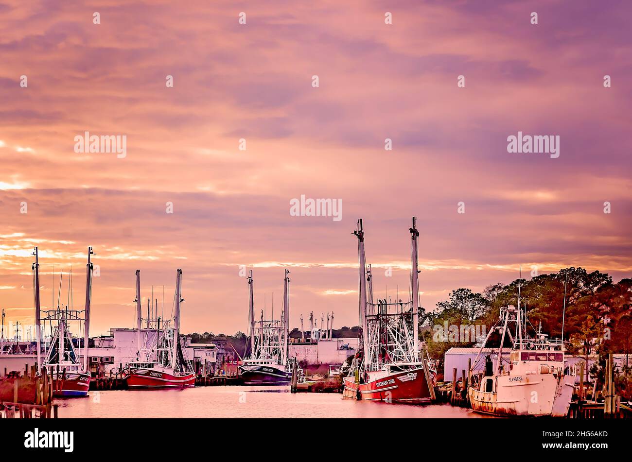 Shrimp boats are pictured at sunset, Jan. 6, 2022, in Bayou La Batre ...