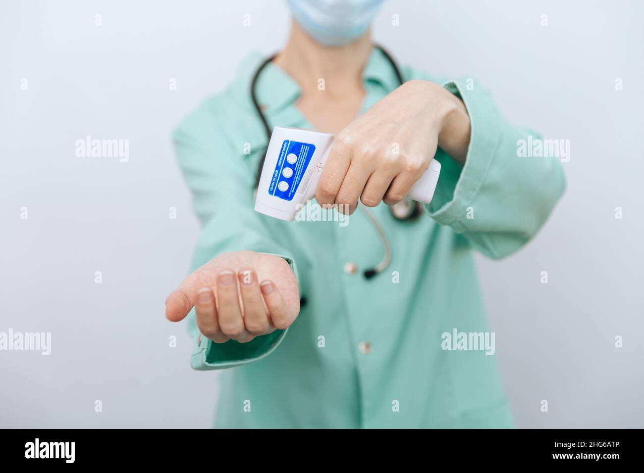 Temperature measurement gun in doctor hands. Close-up shot of doctor ...