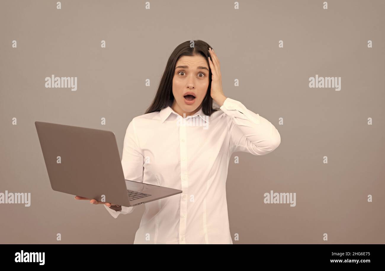 shocked woman in white shirt hold computer has a lot of work, overwork ...