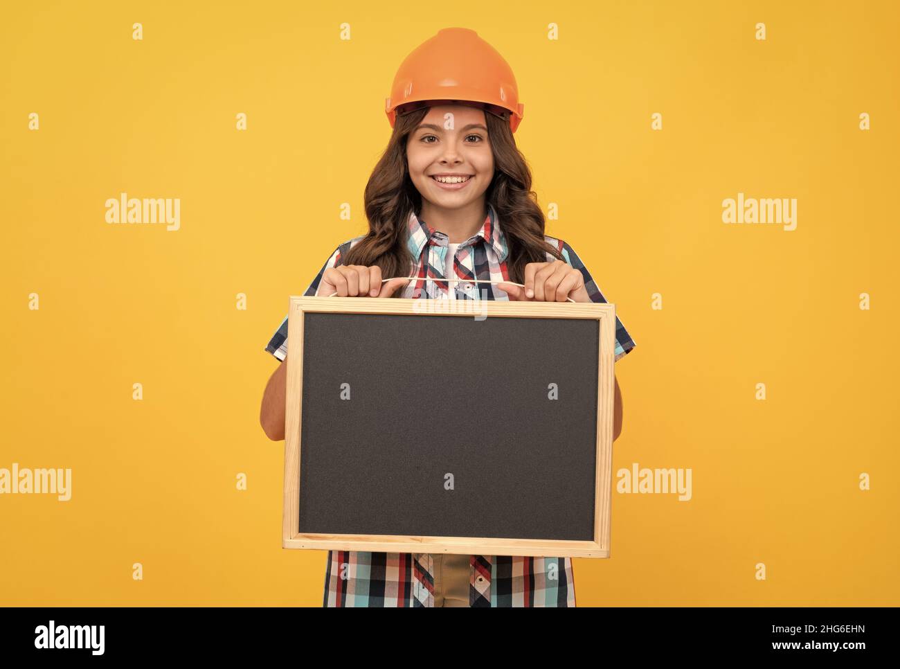 cheerful teen girl laborer hold blackboard. child advertising labor day ...
