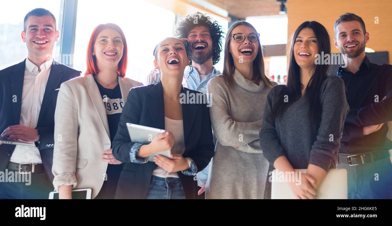 Successful creative business team looking at camera and smiling ... Successful creative business team looking at camera and smiling ...