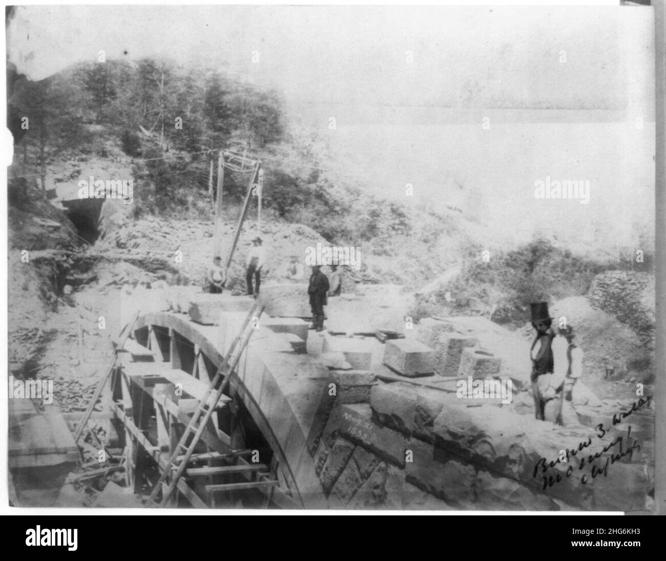 Seven men on a bridge construction Stock Photo - Alamy
