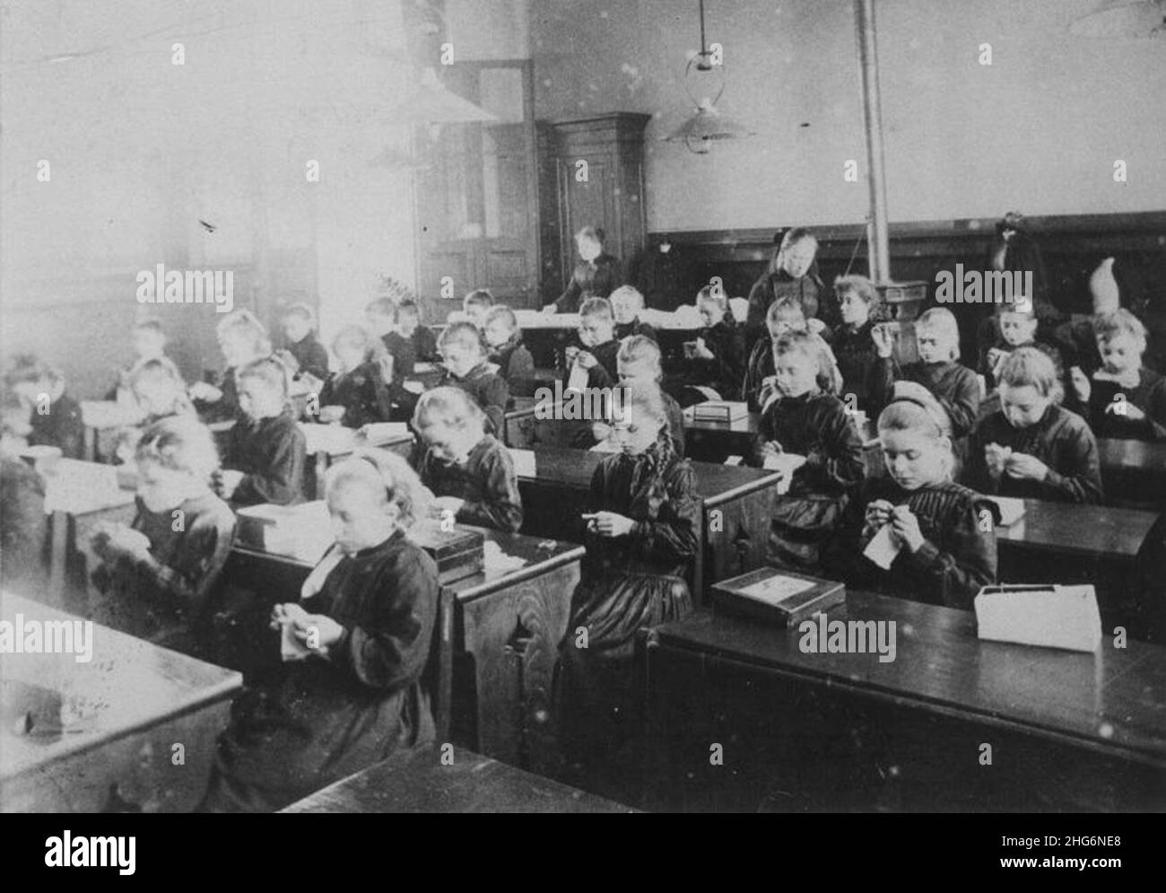 Sewing lesson in a girl class in Hellemmes around 1900 Stock Photo - Alamy