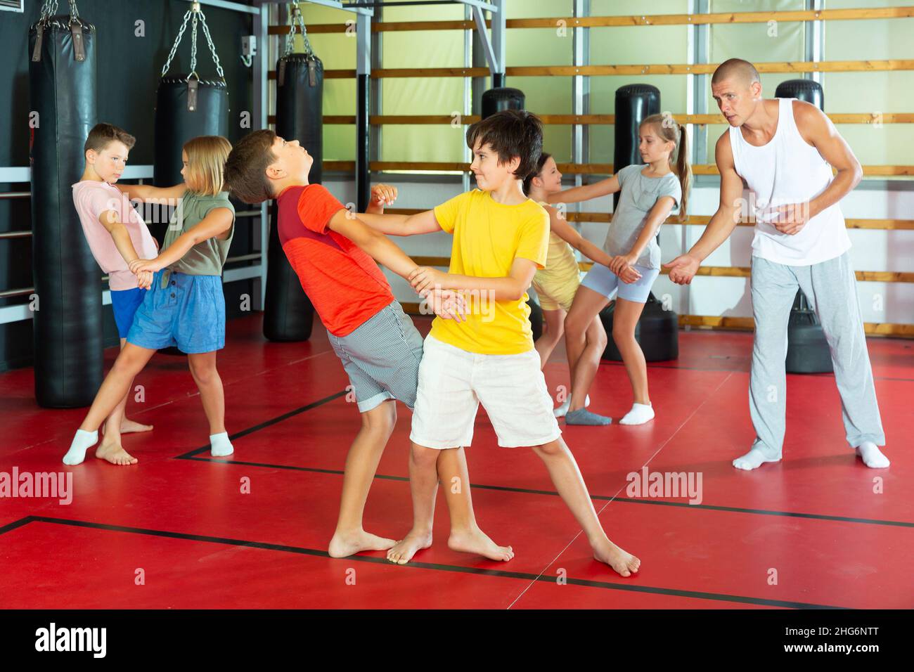 Kids in pair exercising self-defense movements Stock Photo - Alamy