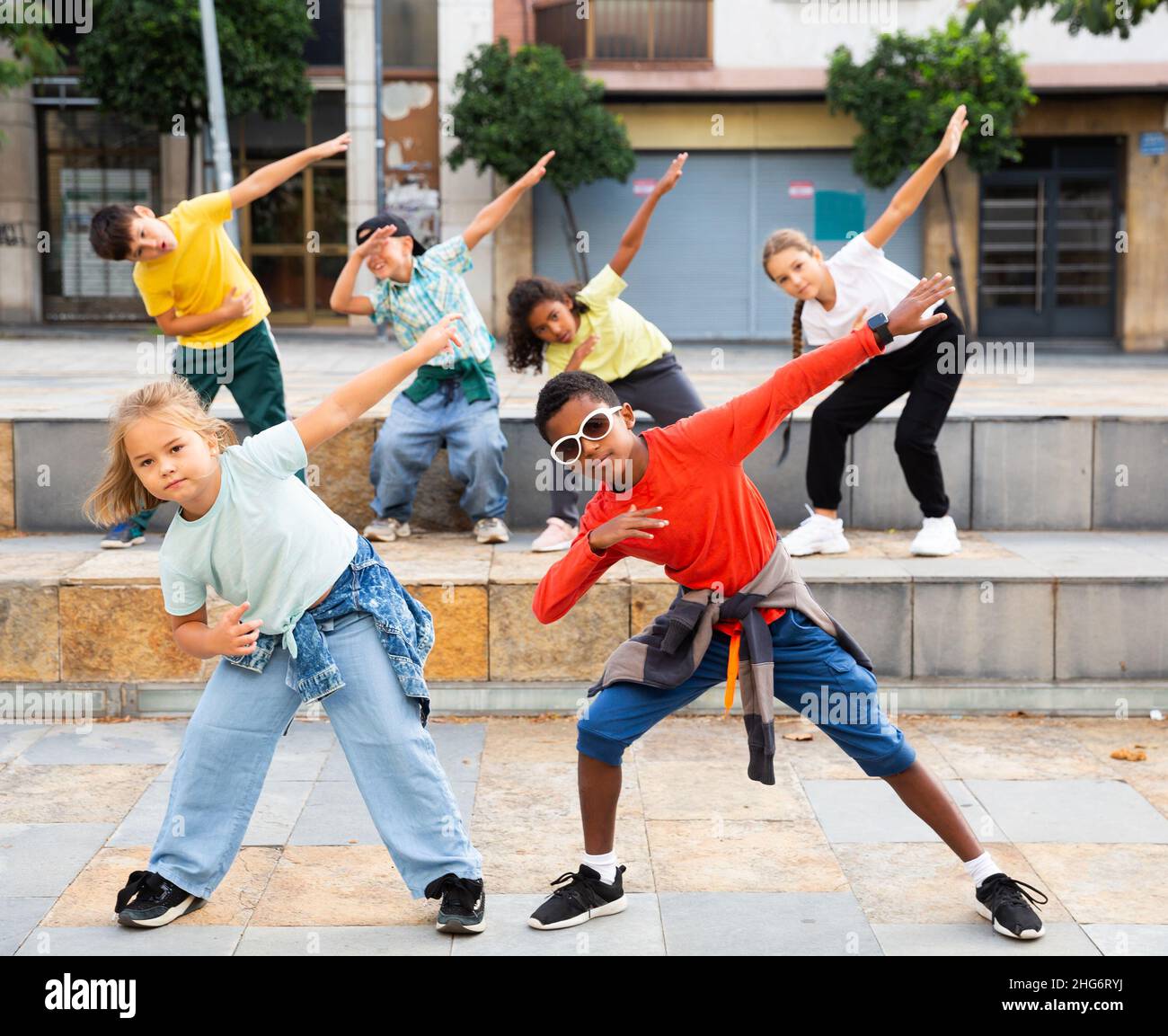 Preteen boys and girls breakdancers dancing on city street Stock Photo ...