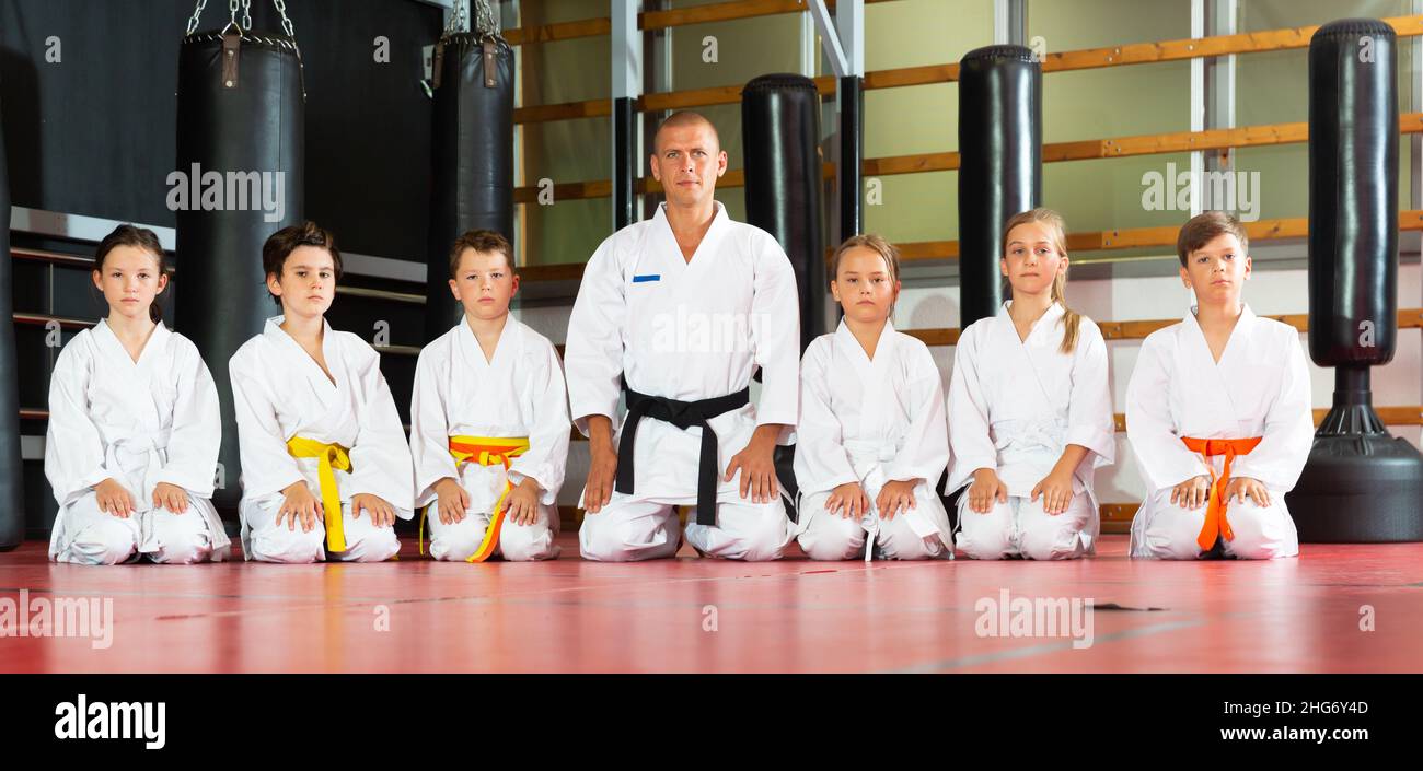Group of karate kids and their trainer Stock Photo - Alamy