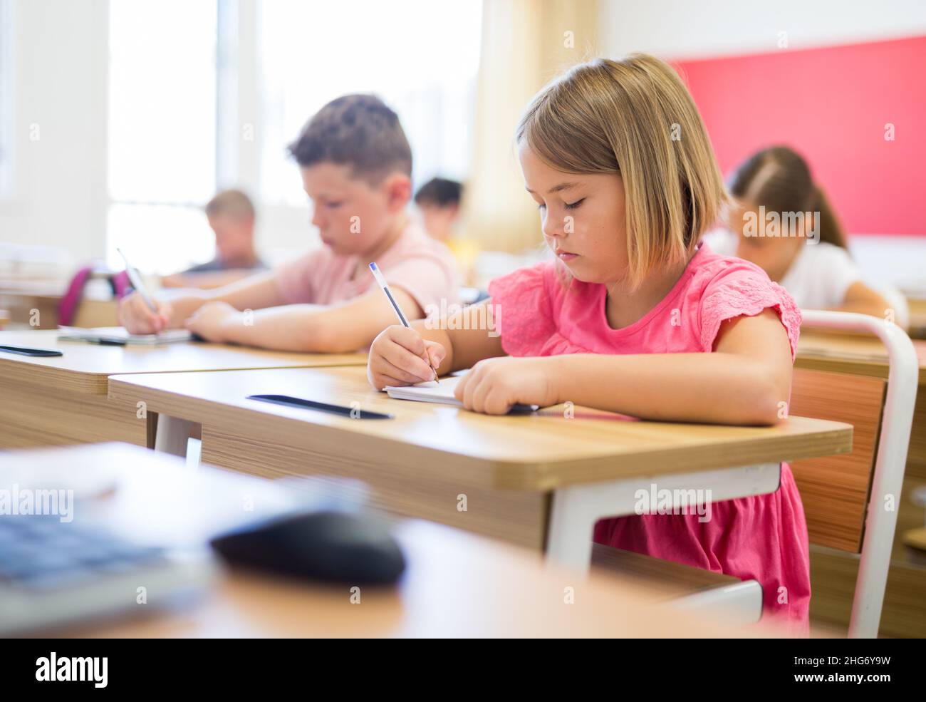 Kids sitting in classroom Stock Photo - Alamy