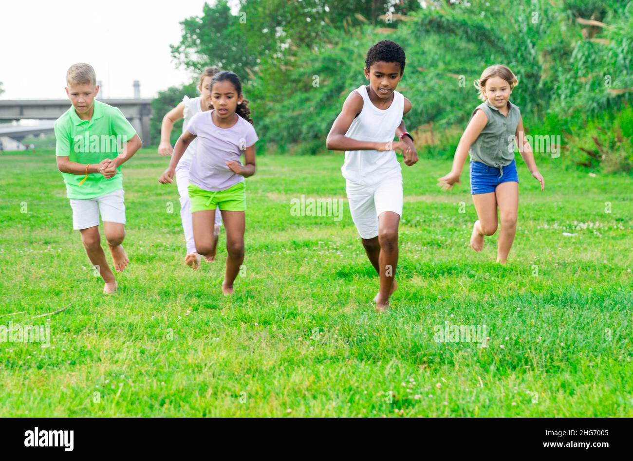 Children running on green grass Stock Photo - Alamy