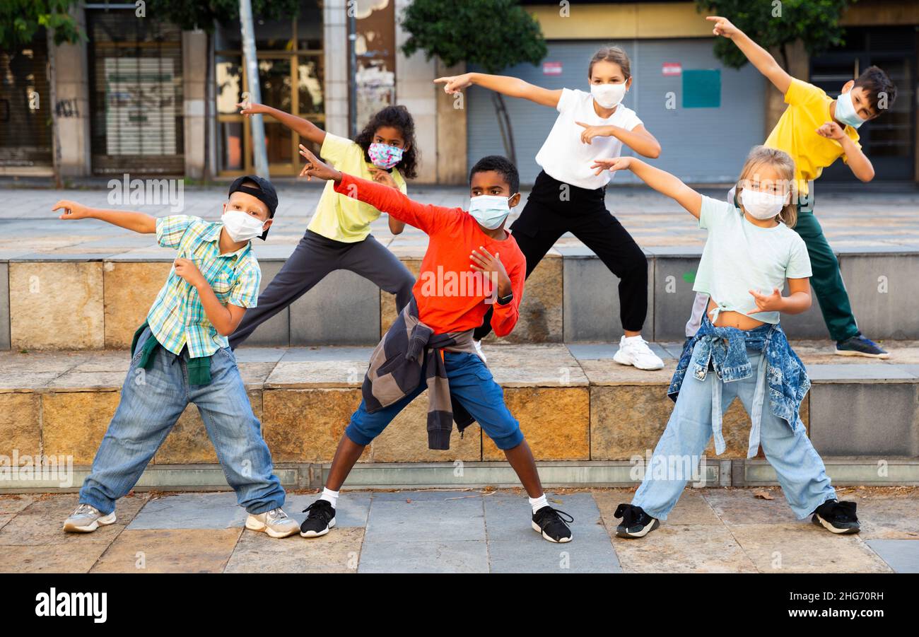 Kids in masks dancing on street Stock Photo - Alamy