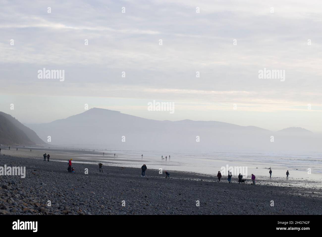 The Oceanside Beach in Oregon is covered with rocks washed ashore on ...
