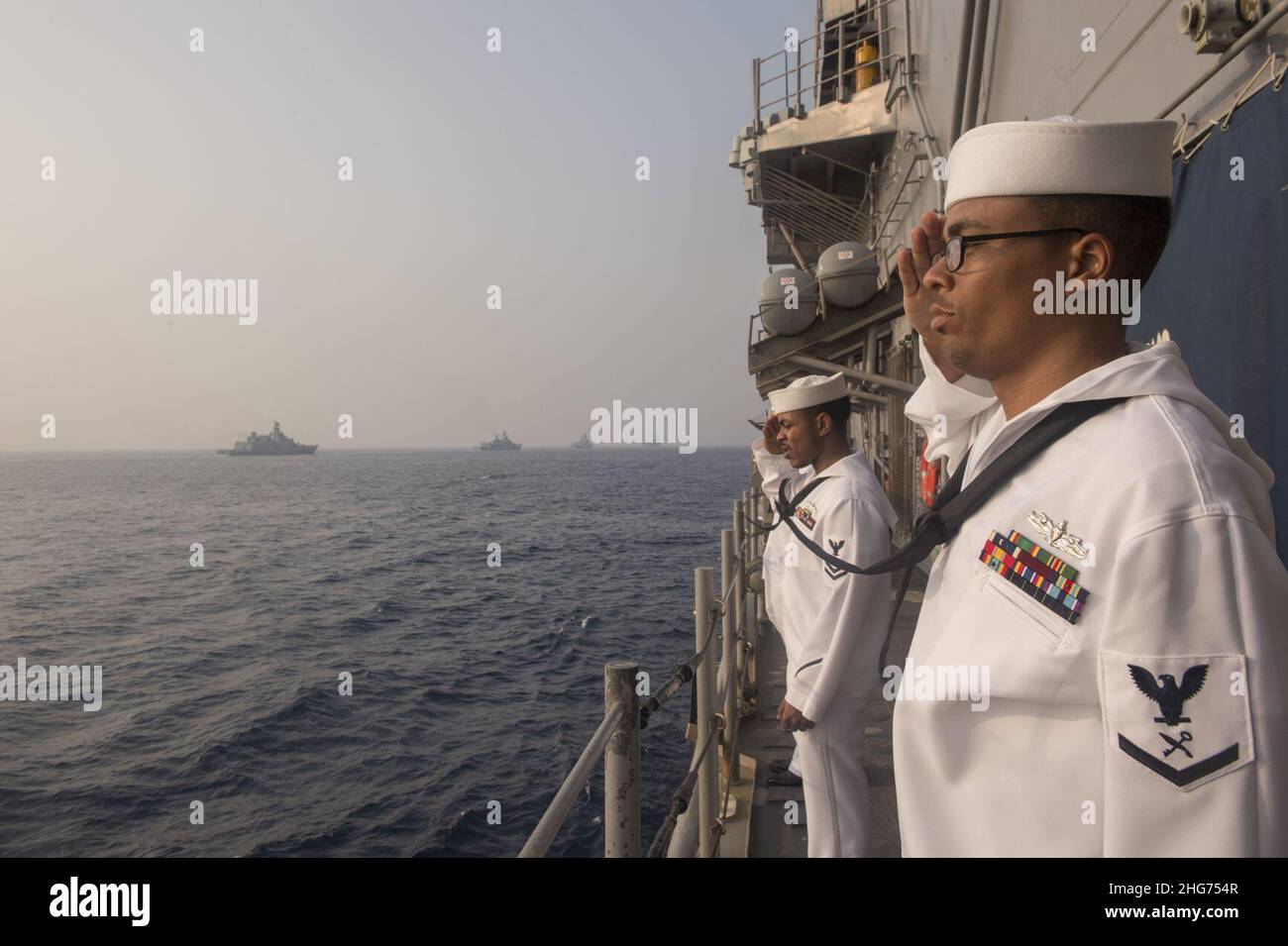 Ship’s Serviceman 3rd Class Christopher Hill renders honors to a column ...