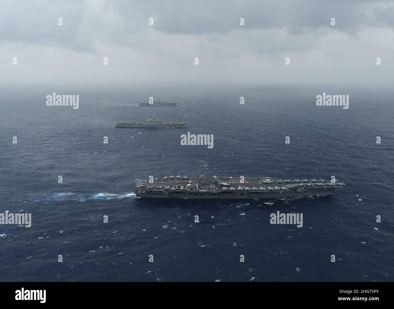 Ships from the Indian Navy, JMSDF and the US Navy sail in formation in ...