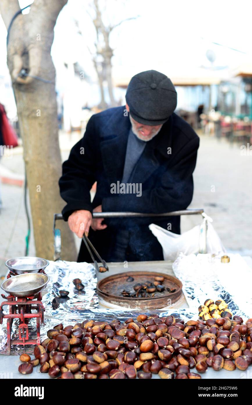 A Turkish man roasting chestnuts on the street in Üsküdar, Istanbul ...