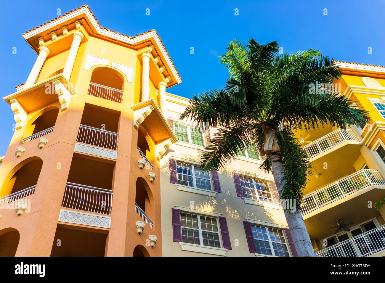 Colorful condo apartment balcony building with orange pastel yellow ...