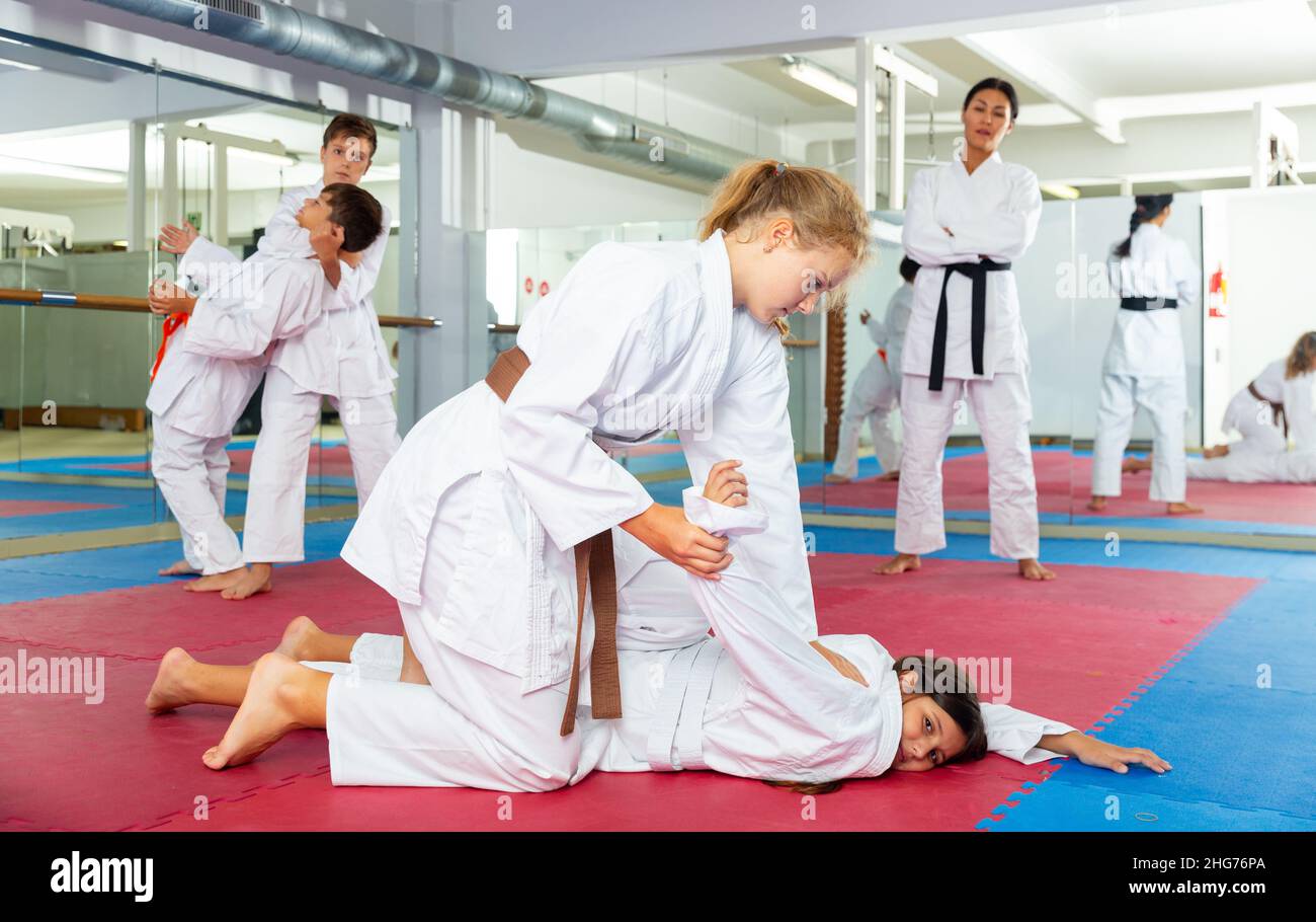 Boys performing arm lock movement during karate training Stock Photo ...