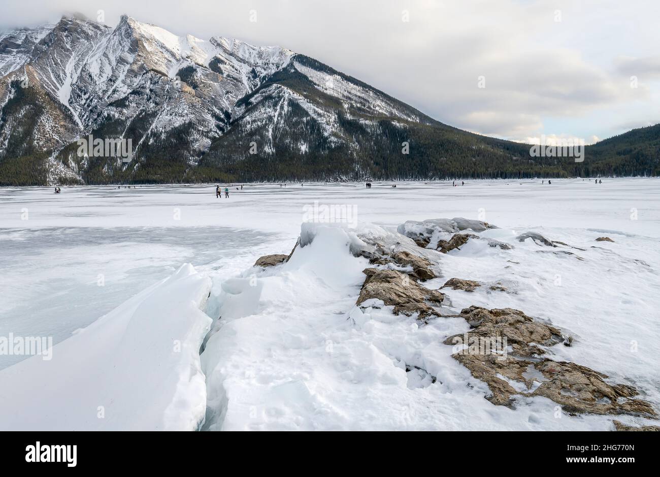 Skating and hiking on frozen Lake Minnewanka in Banff National Park ...