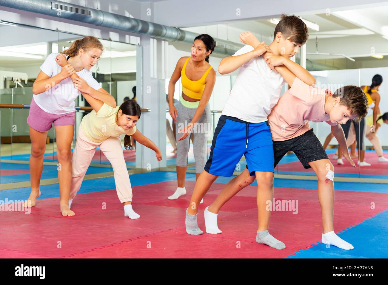 Two boys learn to do a painful hand grip in self-defense lesson Stock ...