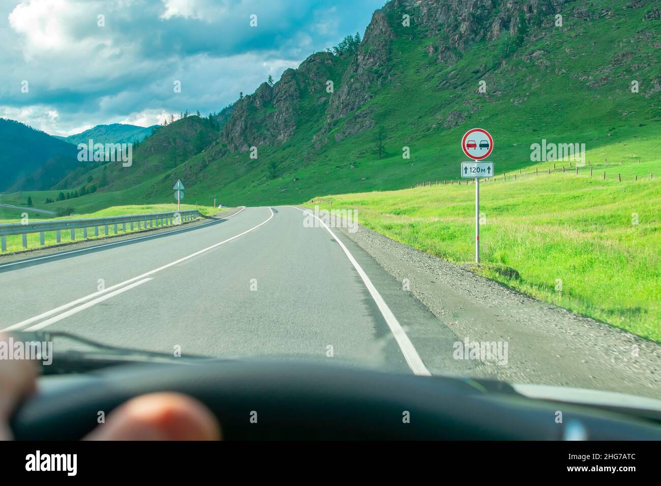 view of the road sign prohibiting overtaking from the car interior ...