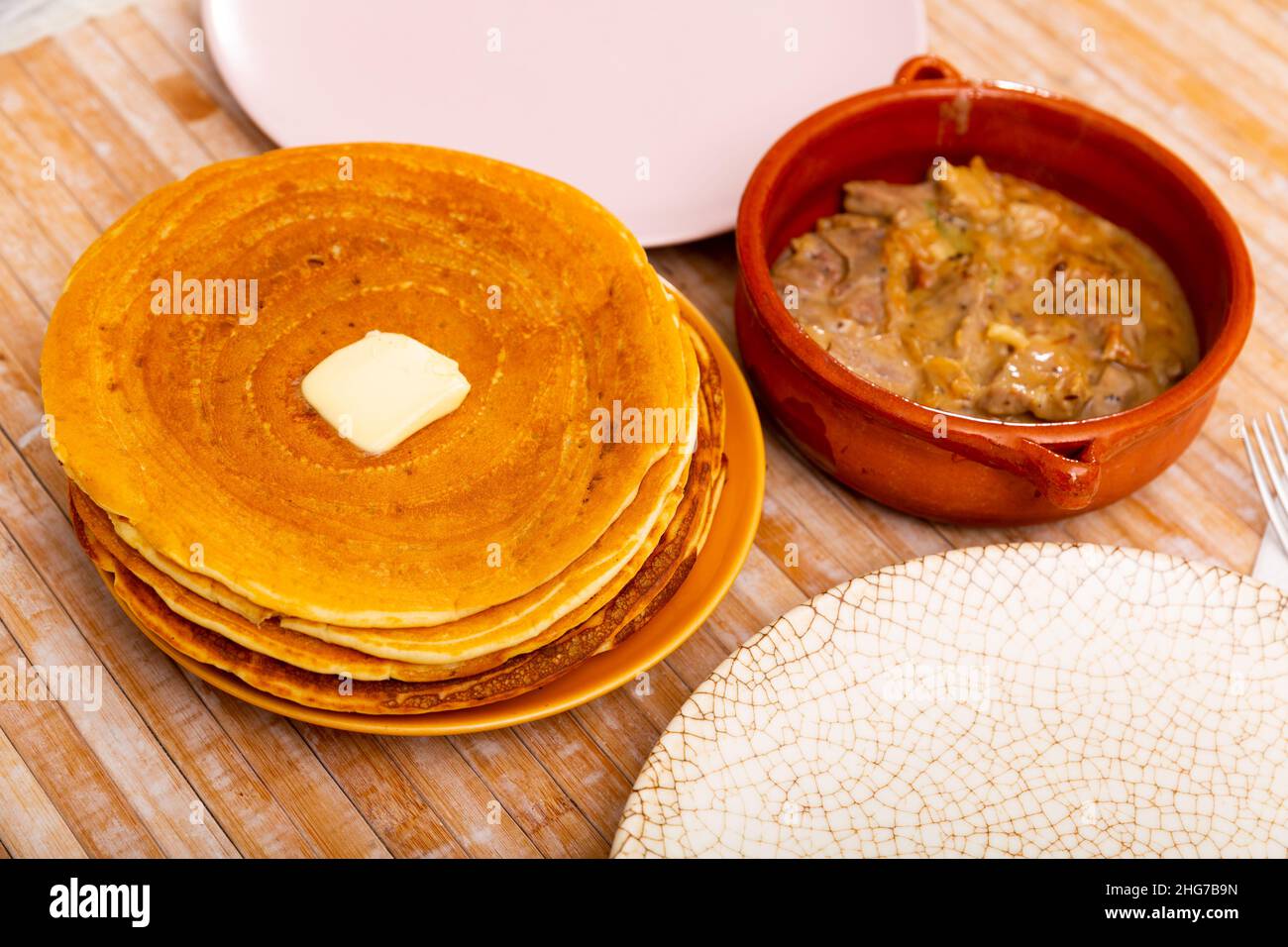 Pancakes with meat and vegetables stew machanka Stock Photo - Alamy