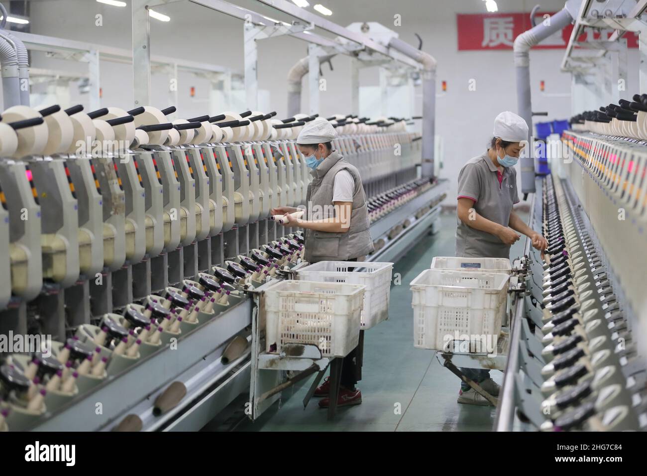 YUNCHENG, CHINA - JANUARY 18, 2022 - Workers operate at a spinning ...