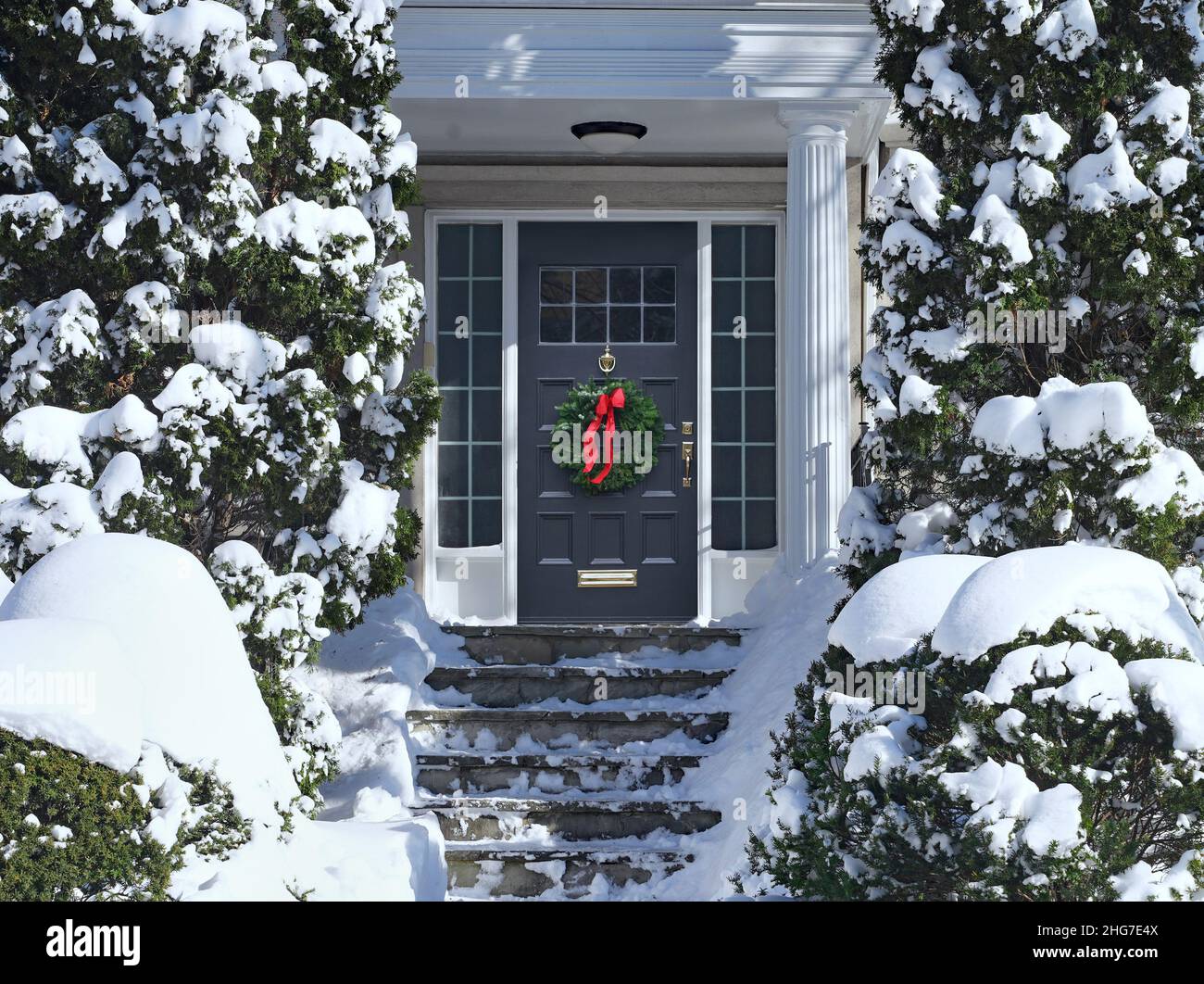Front door of house with colorful wreath and portico entrance ...