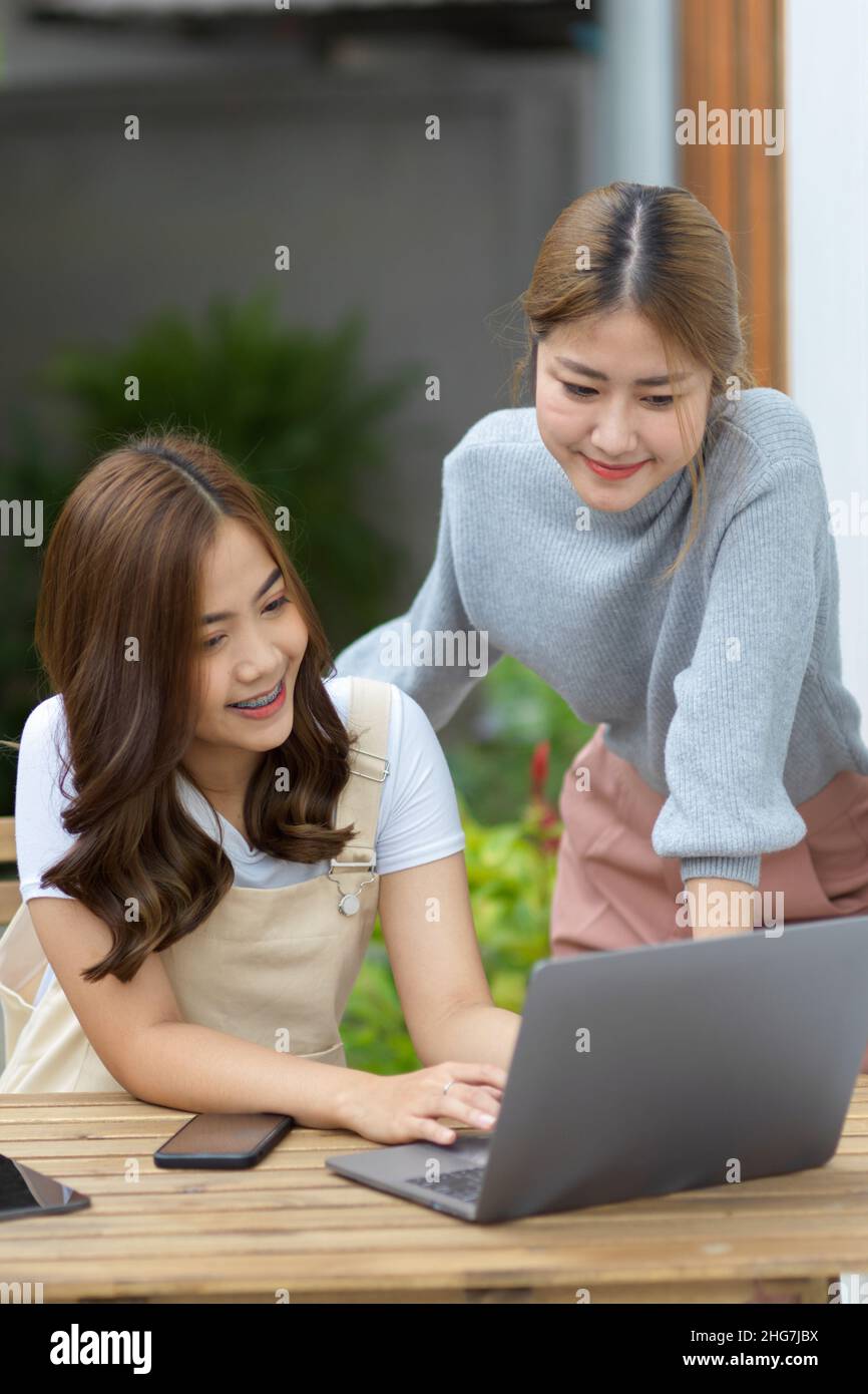 A beautiful Asian young university student teaches and coaches math ...