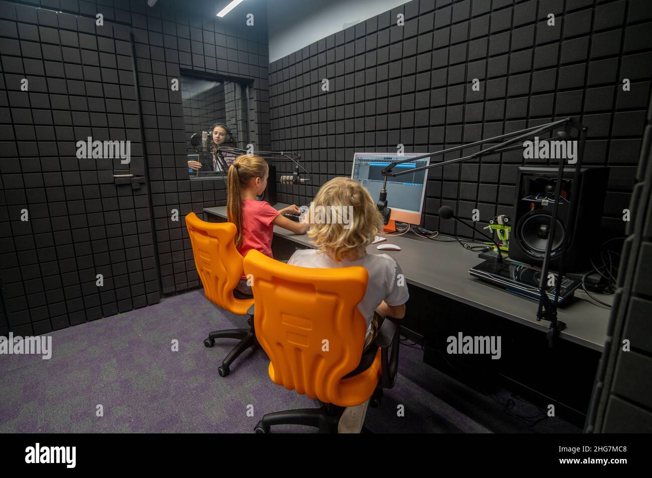 Kids monitoring the sound quality in the studio Stock Photo - Alamy