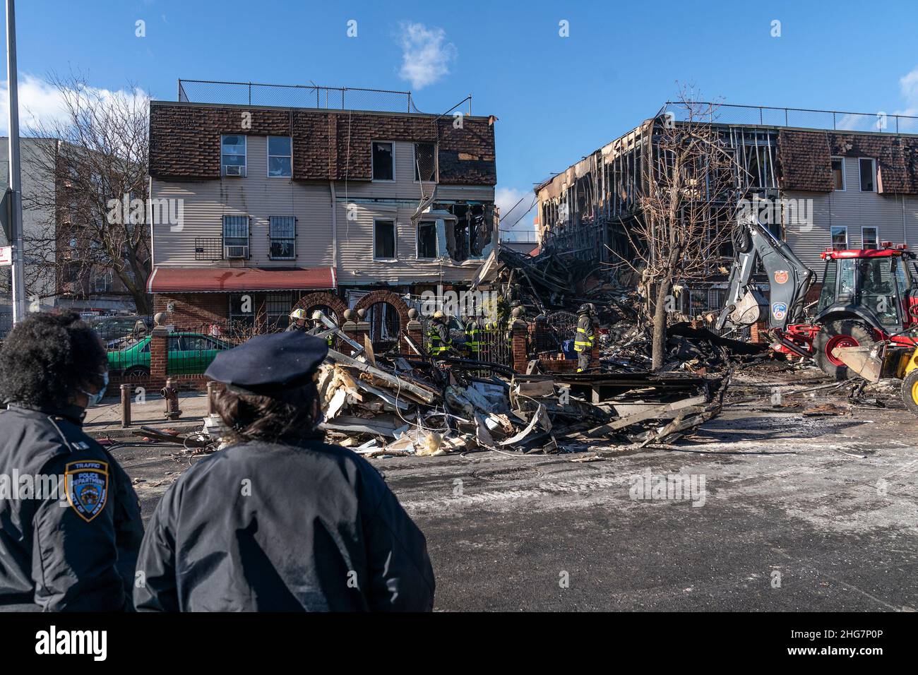 Firefighters work on raw houses affected by 2 alarm fire and possible ...