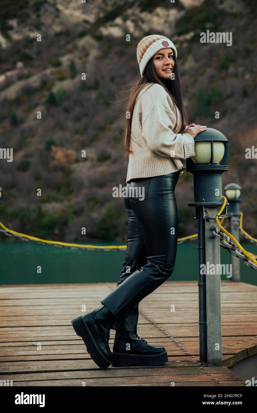 Portrait of a brunette girl standing on a jetty Stock Photo - Alamy