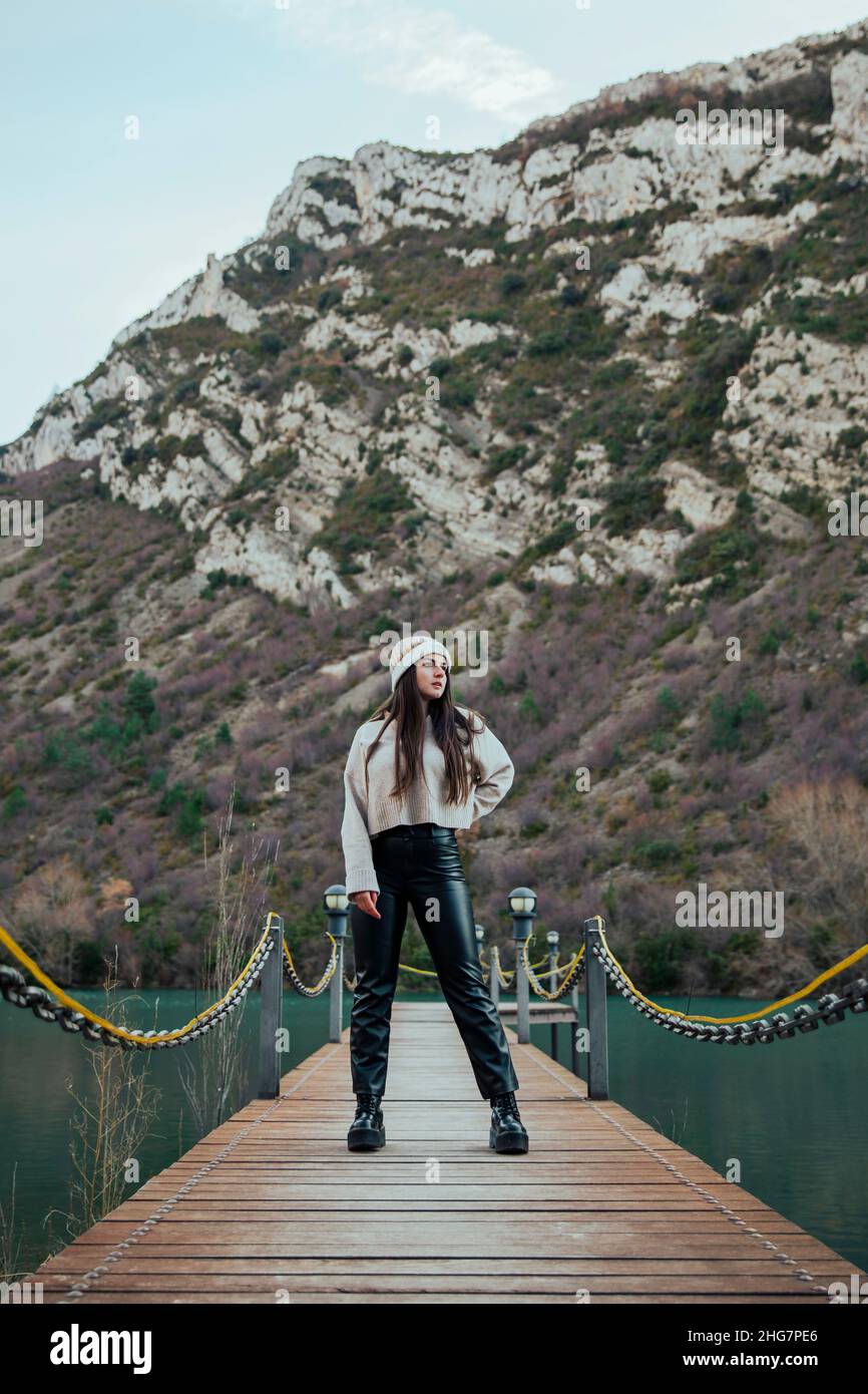 Portrait of a brunette girl standing on a jetty Stock Photo - Alamy