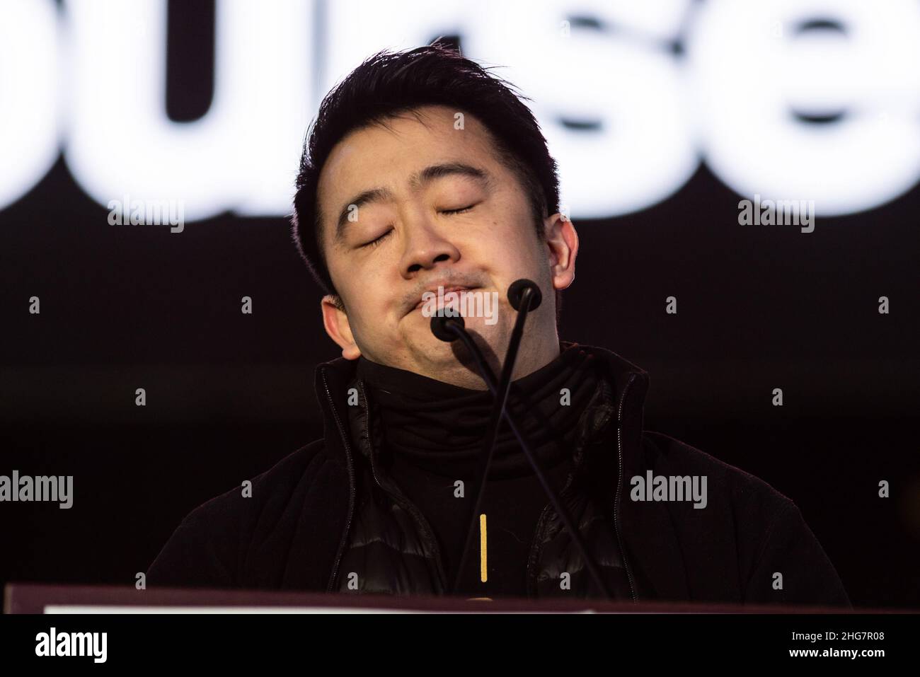 Asian Fighting Injustice Founder Ben Wei speaks at a candlelight vigil ...