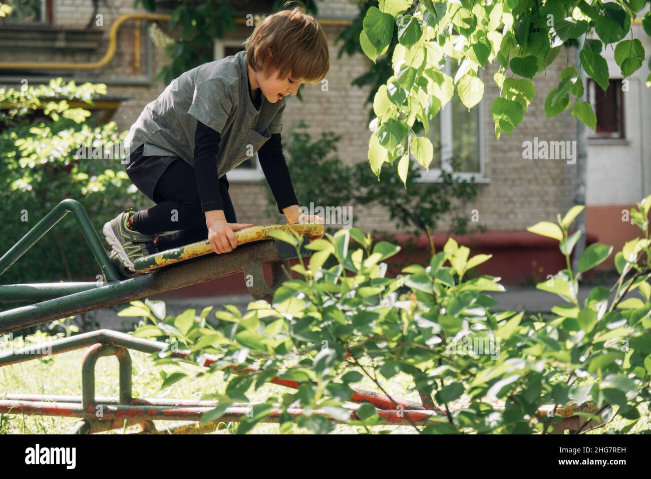 Kid playing in the yard Stock Photo - Alamy