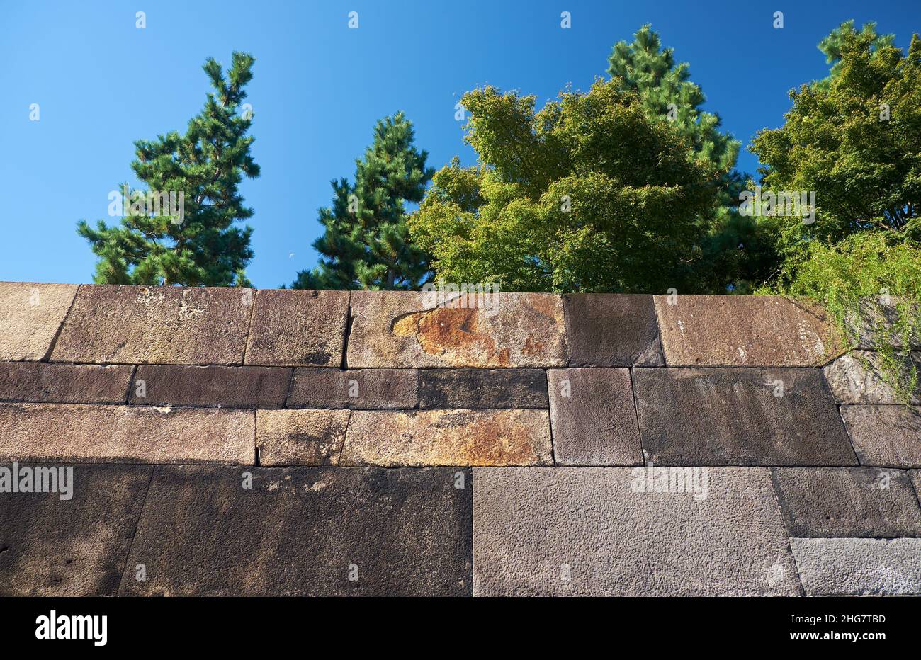 The view of the old defensive stone wall of Edo castle topped with the ...