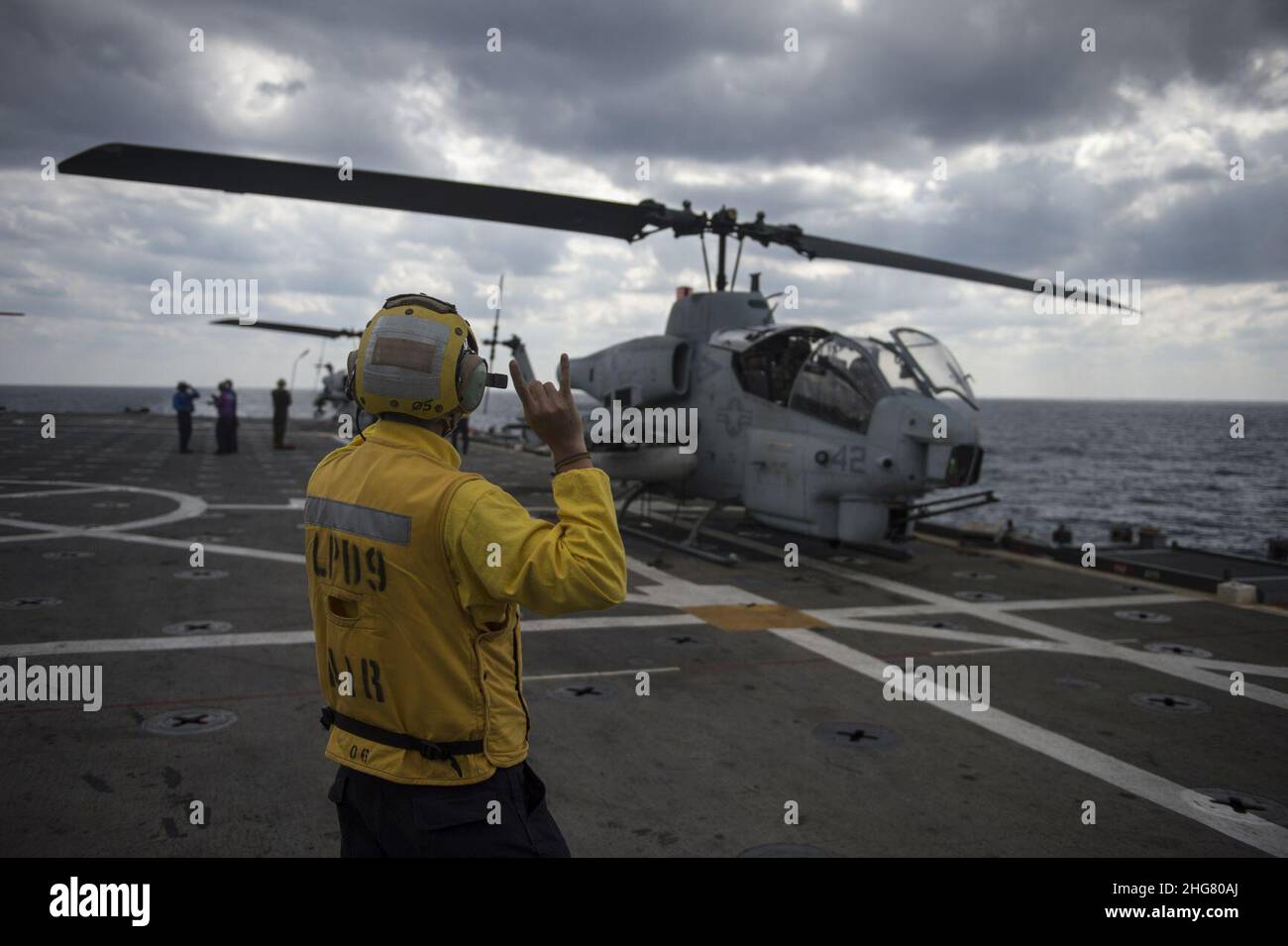 Signaling a AH-1W Super Cobra light attack helicopter 140311 Stock ...