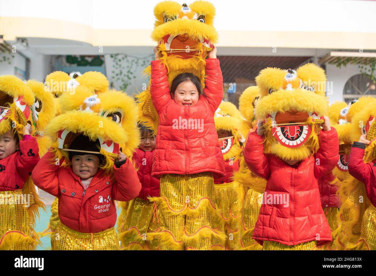 HAI'AN, CHINA - JANUARY 19, 2022 - Kindergarten children perform a lion ...