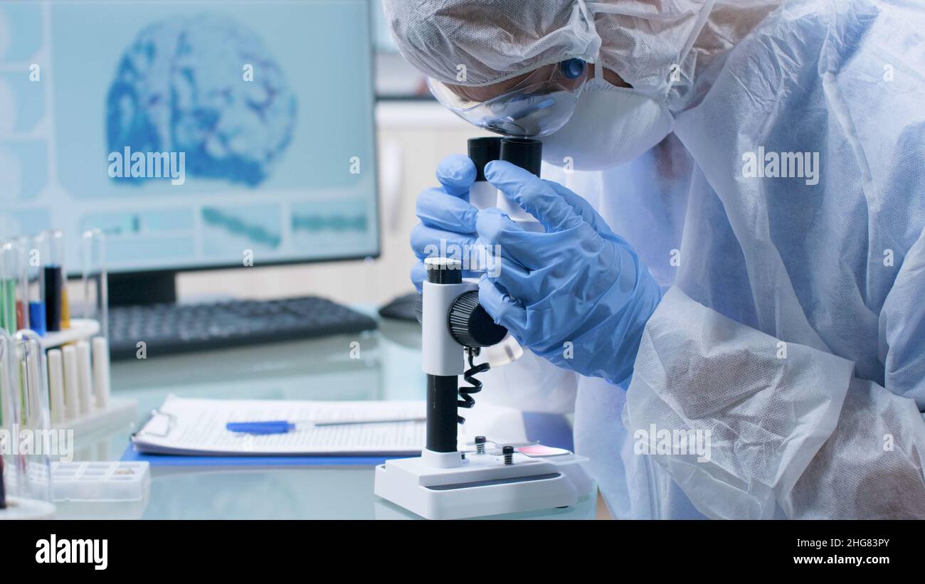 Closeup of scientist doctor researcher wearing ppe equipment analyzing ...