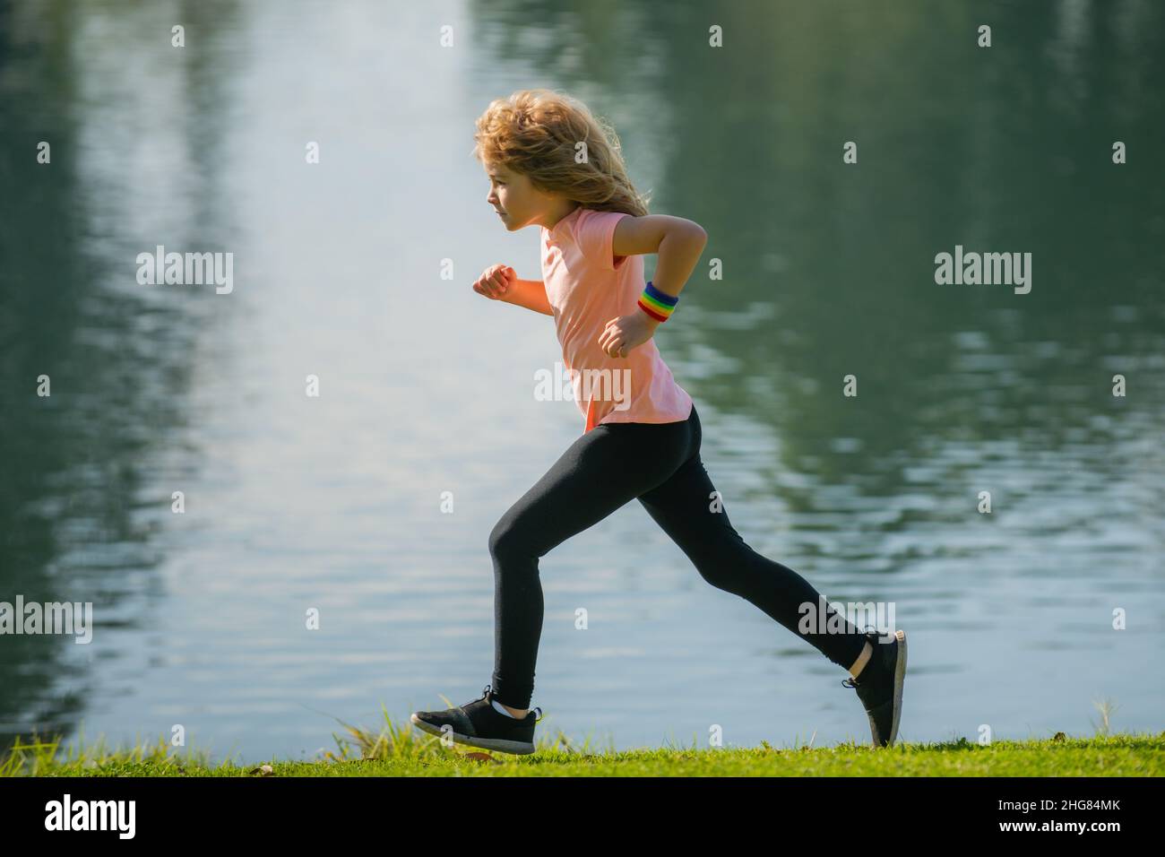 Kid runners run on lawn in park. Child running outdoor. Healthy sport ...