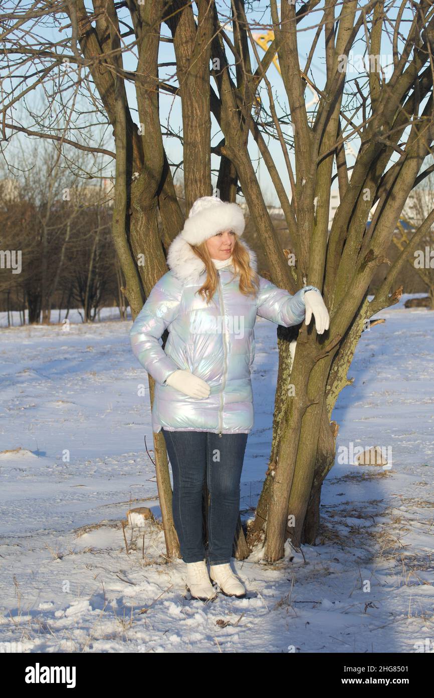 Portrait of a girl in winter clothes. Woman posing on a walk in a ...