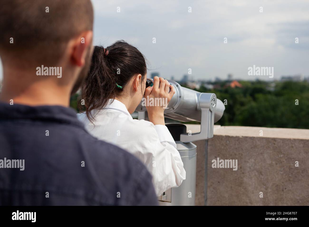 Young lovers celebrating relationship anniversary on building tower ...
