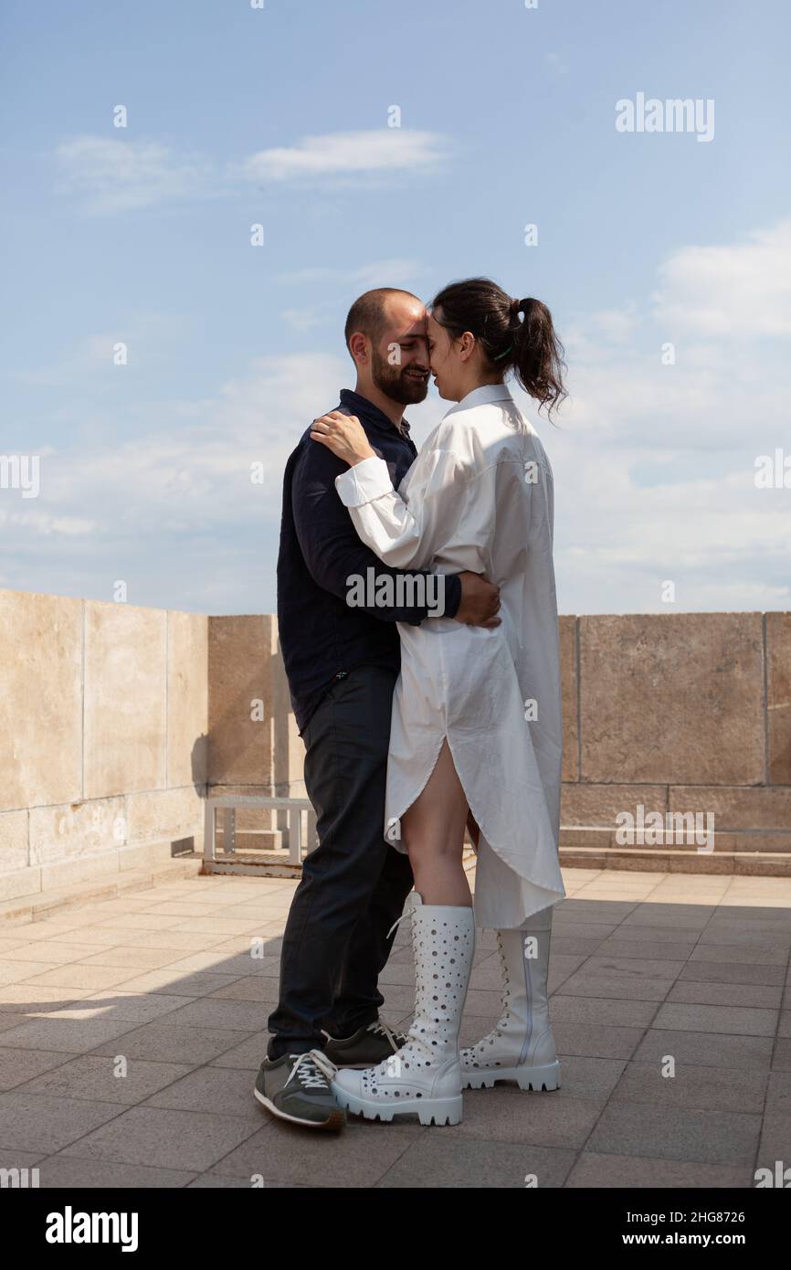 Happy romantic couple hugging during relationship anniversary standing ...
