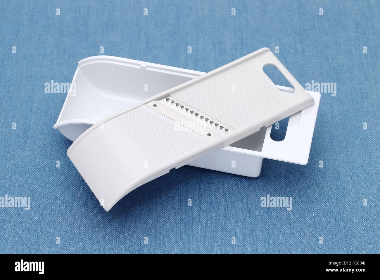 vegetable cutter and slicer with metal blades on a white background ...