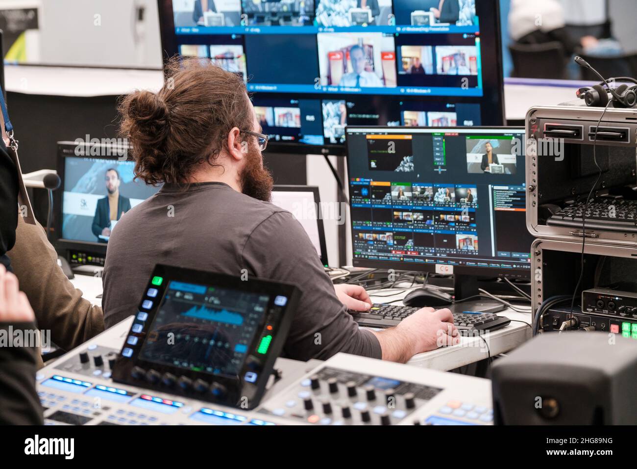 Back view of male engineers using laptops and and computer displays for ...