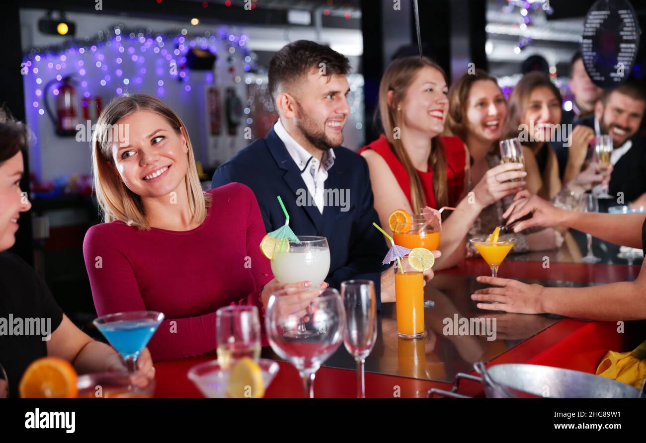 Woman with colleagues enjoying corporate party in bar Stock Photo - Alamy