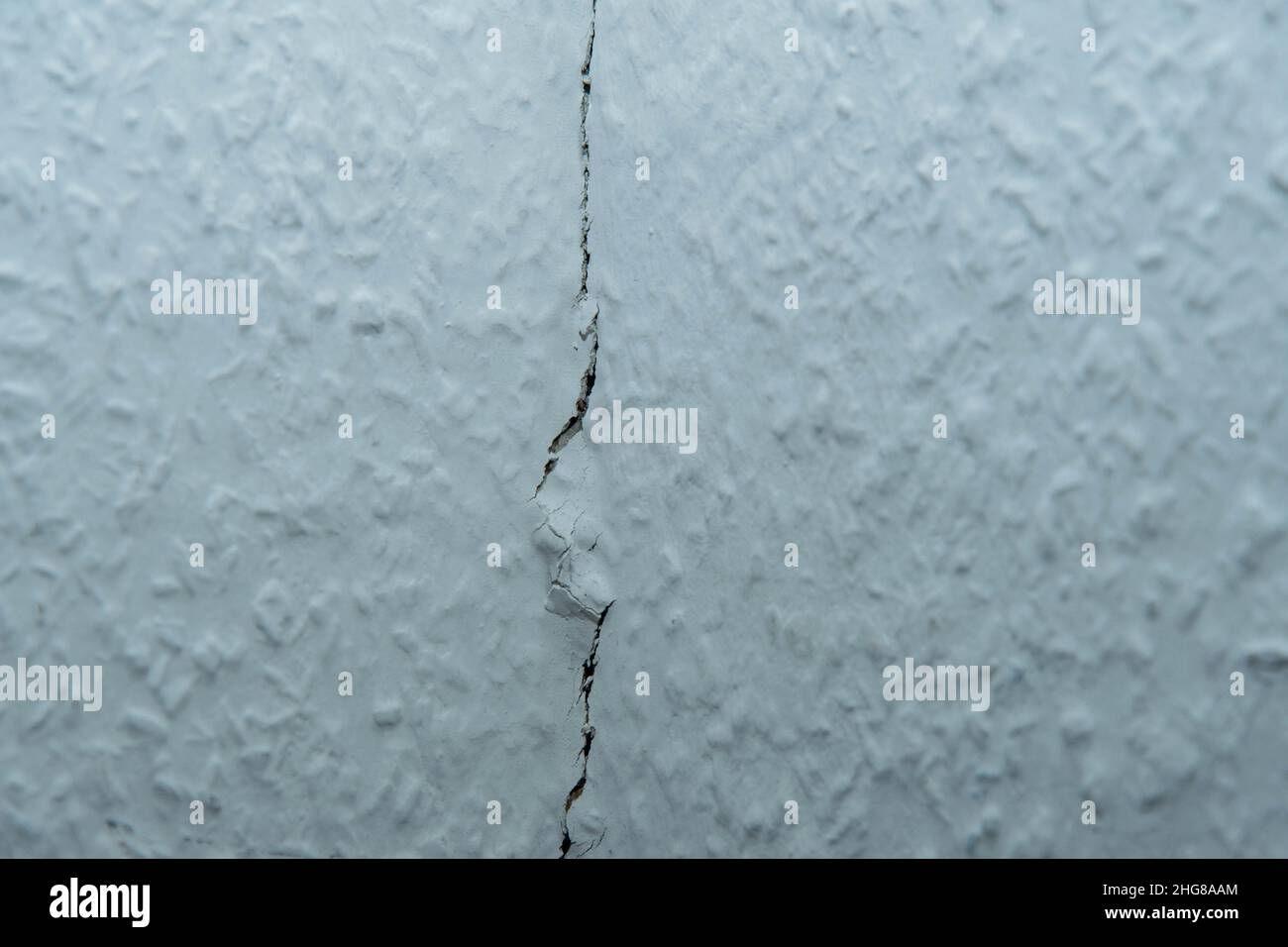 Damage to the wall Crack in the wallpaper Stock Photo - Alamy